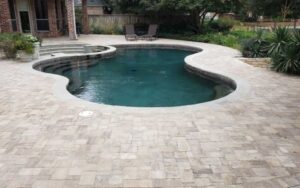 The Cost of Laying Pavers Around a Pool - Backyard Advisor